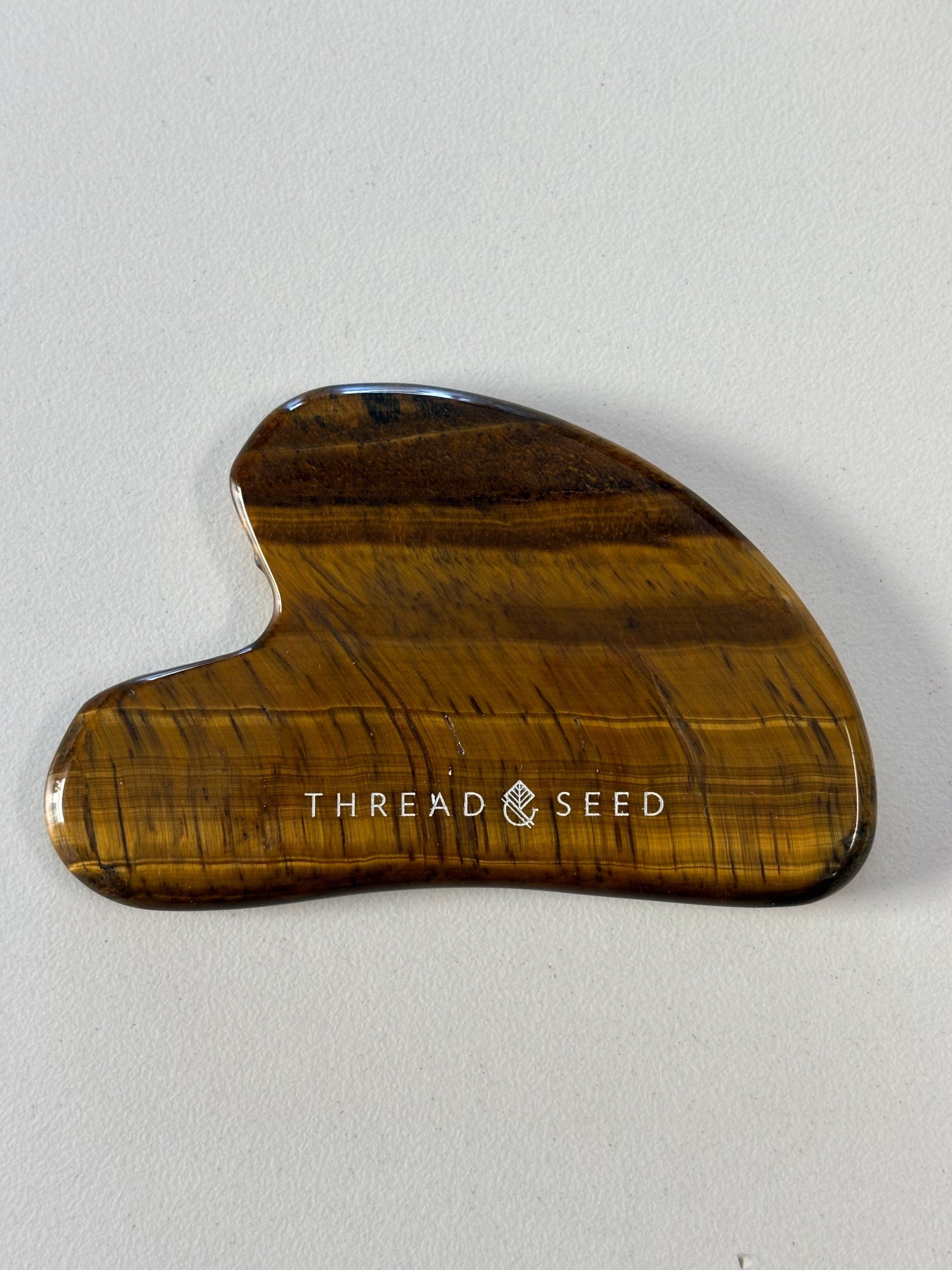 The Tiger's Eye Gua Sha by Thread + Seed